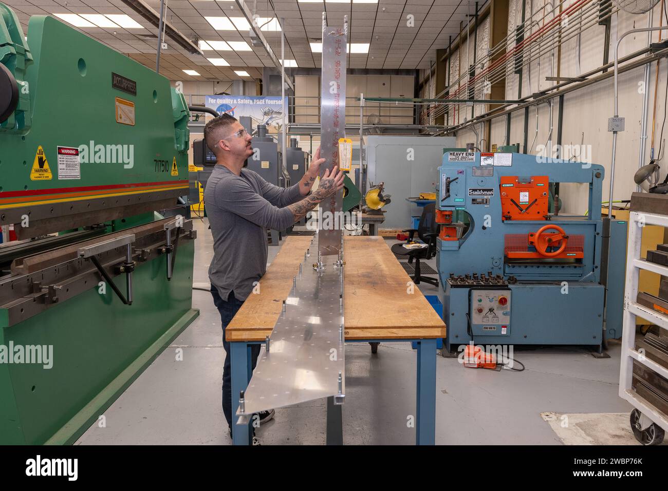 Matthew Sanchez attaches the strut and the wing to ensure they fit ...