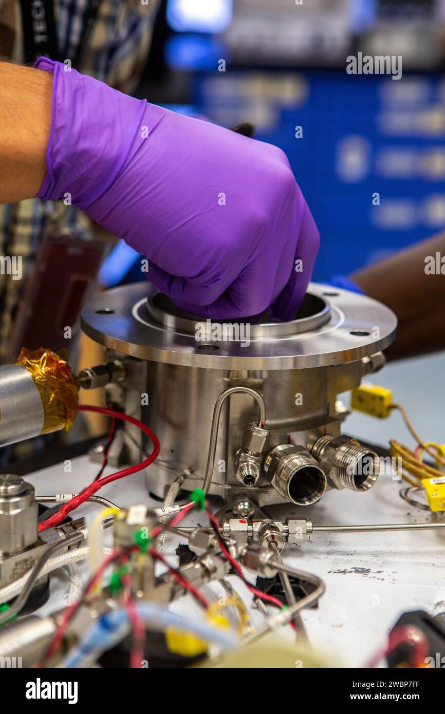 Technicians wearing protective equipment perform work for a future ...