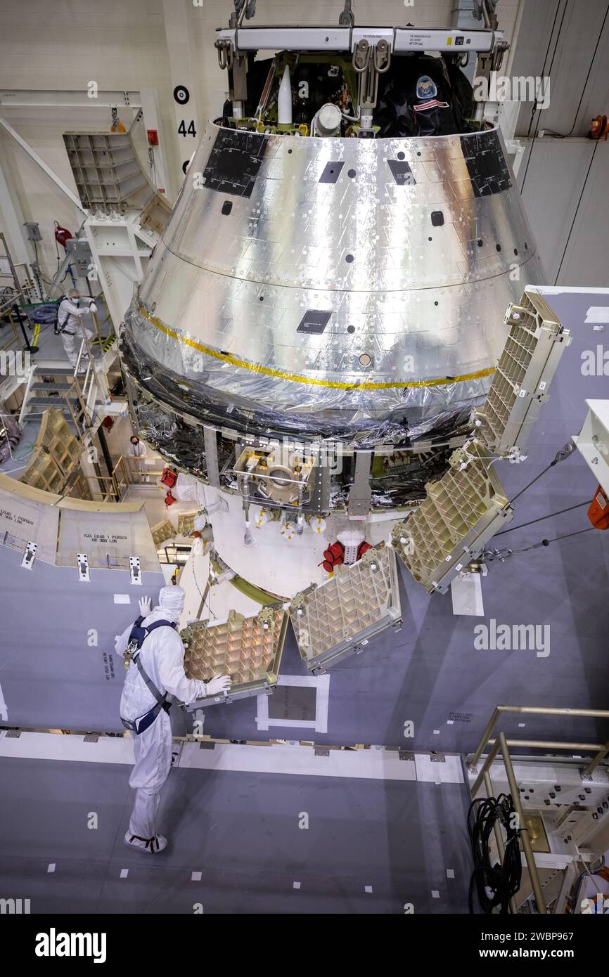 Technicians at NASA’s Kennedy Space Center in Florida work to safely ...