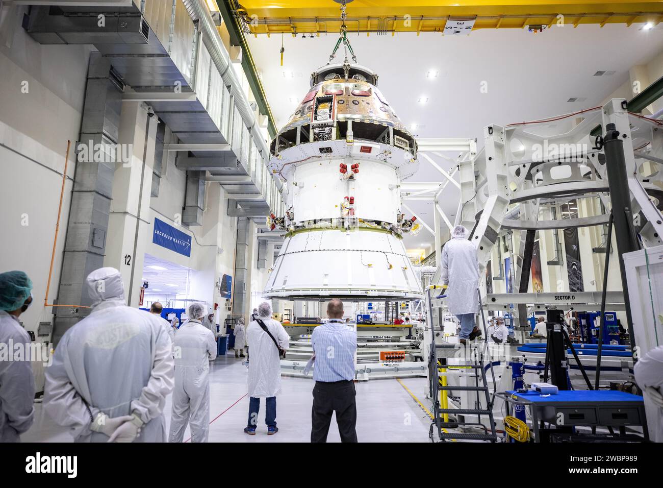 Technicians at NASA’s Kennedy Space Center in Florida work to safely ...