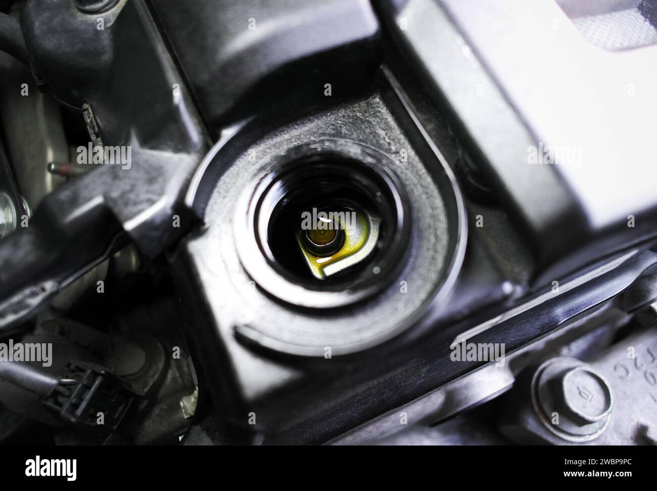 Close up inside a engine oil filler vent of a car engine in engine ...