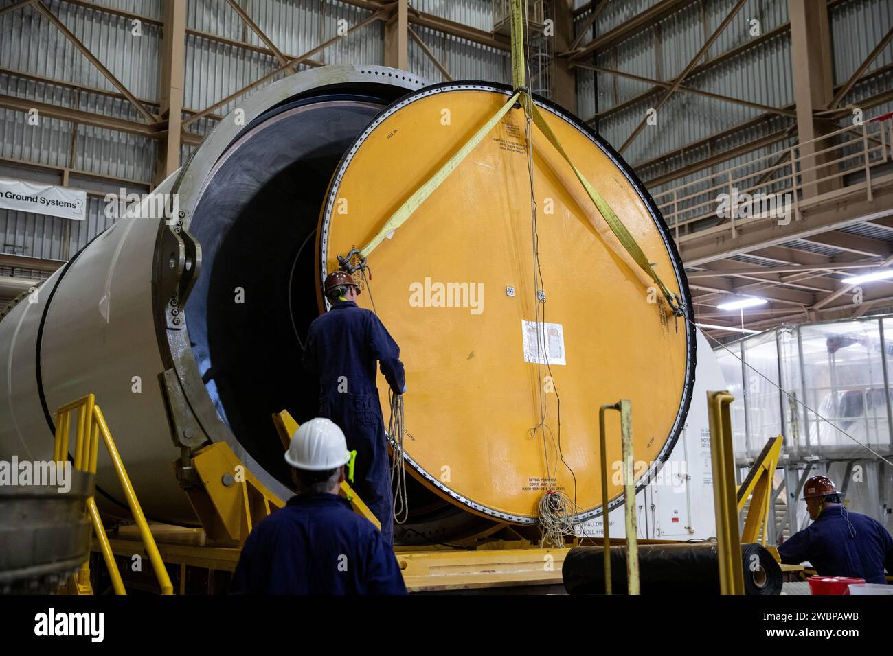 Engineers and technicians process the right forward center segment of the Space Launch System ...