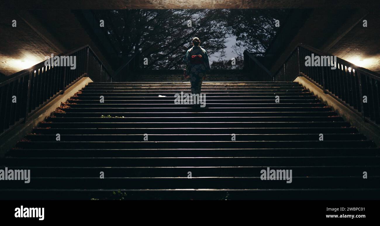 Japanese woman, kimono and walking on stairs at night, city and light ...