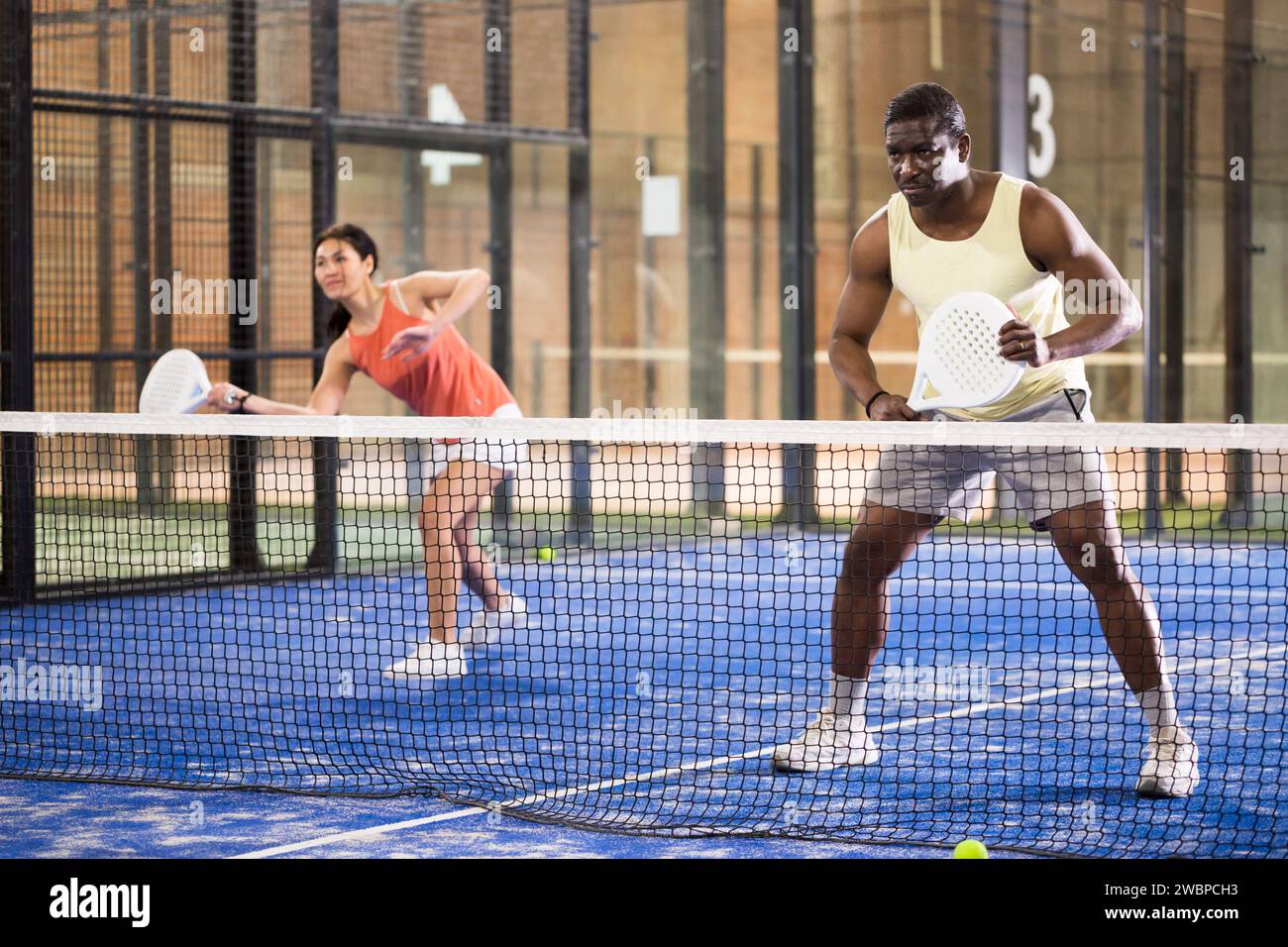 Team of padel players man and woman playing doubles Stock Photo - Alamy