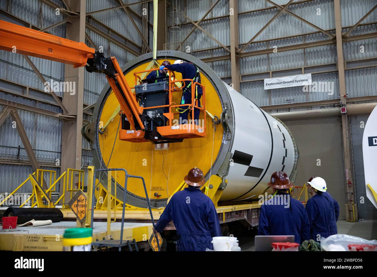 Engineers and technicians process the right forward center segment of the Space Launch System ...