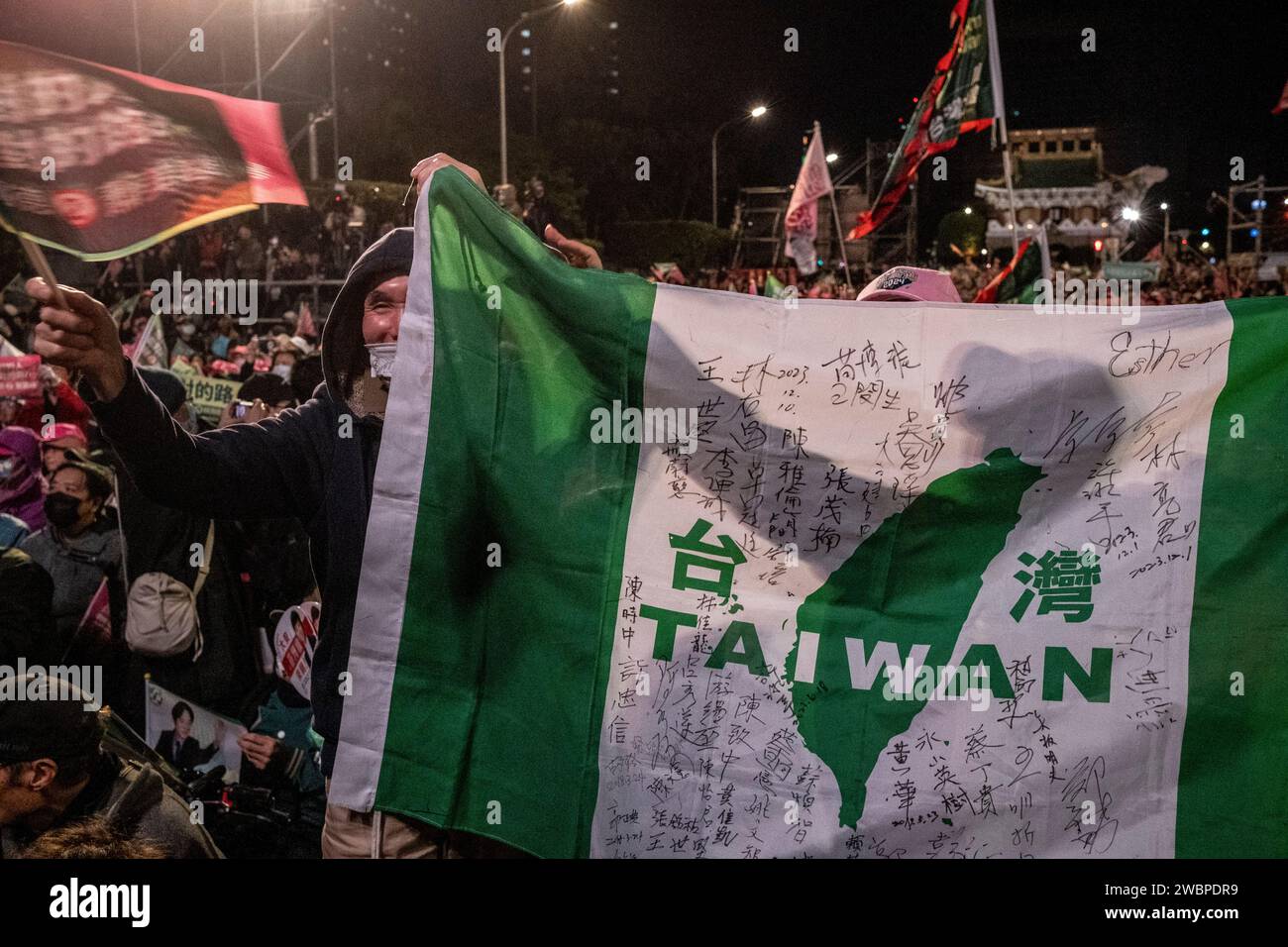 Taiwan, Jan 11, 2024. Supporters holding a Taiwan flag signed with TPP ...