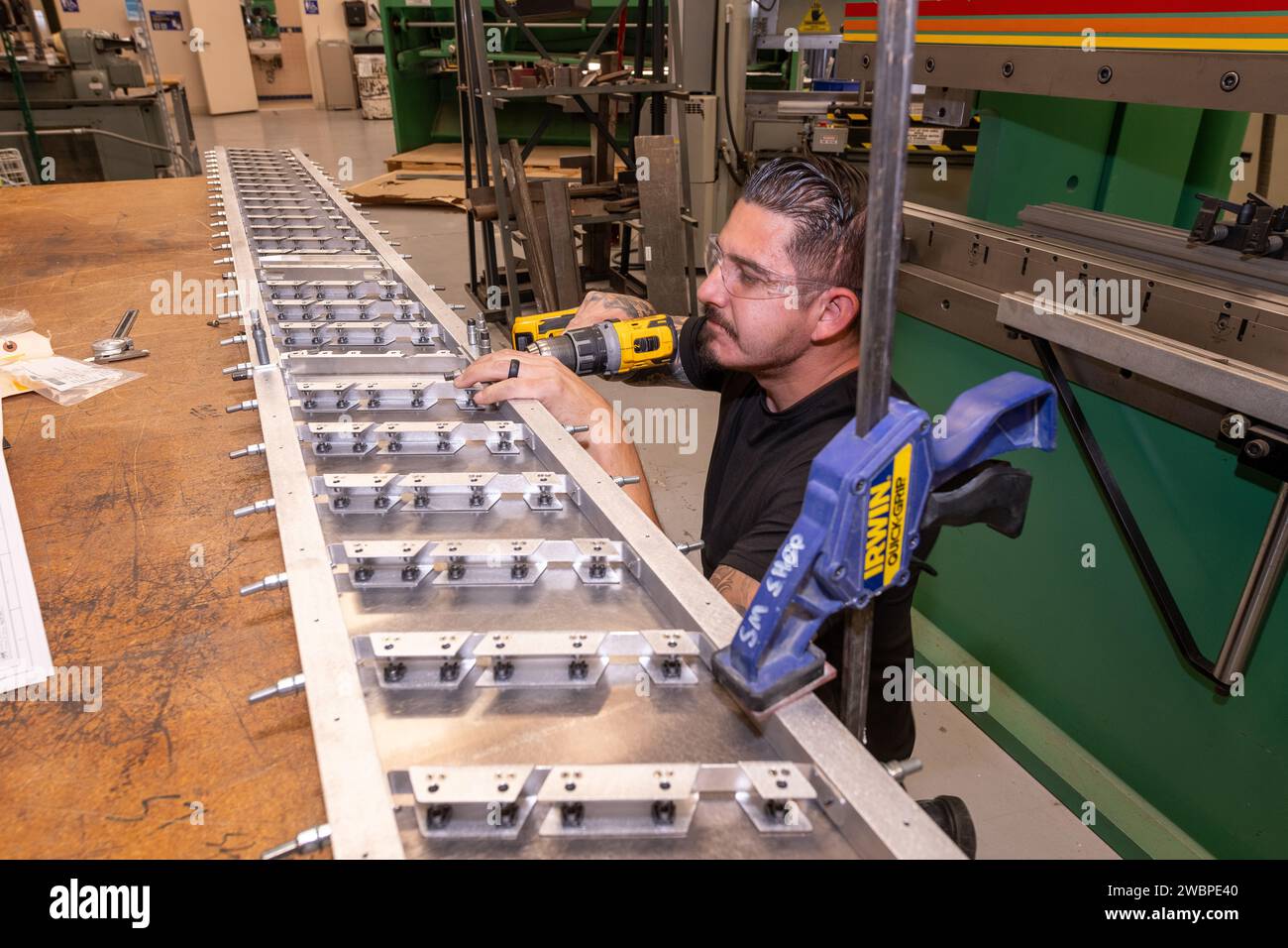 Matthew Sanchez assembles wing ribs to the 10-foot model of the ...