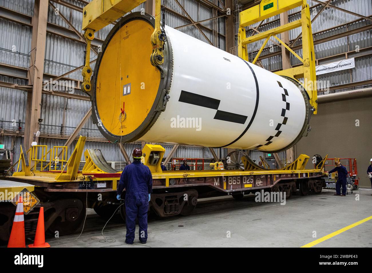 Engineers and technicians process the right forward center segment of ...