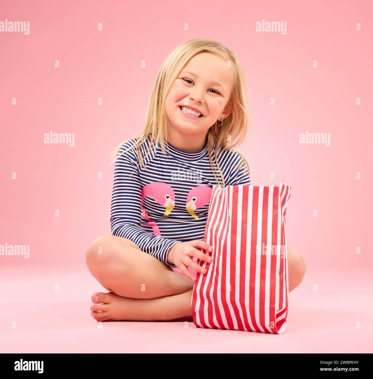 Popcorn, food and happy girl portrait in a studio with pink background ...