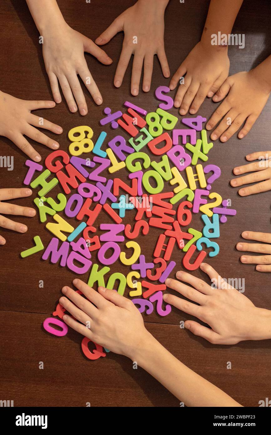 Kids showing colorful plastic numbers. Pre schoolers learning math at ...