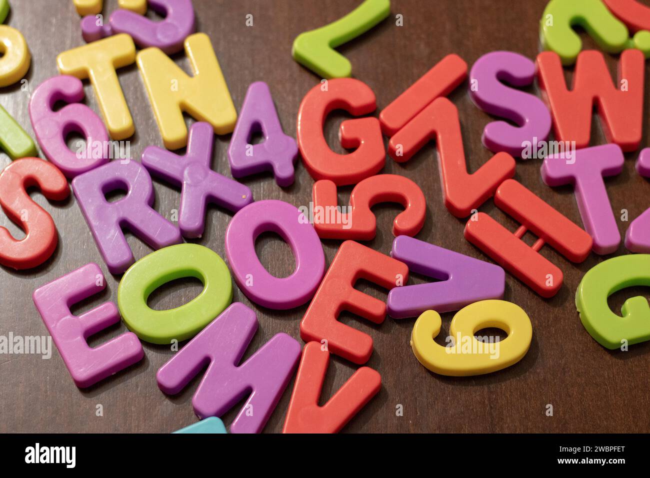 Kids hands with colorful plastic numbers on brown table. Top view Stock ...