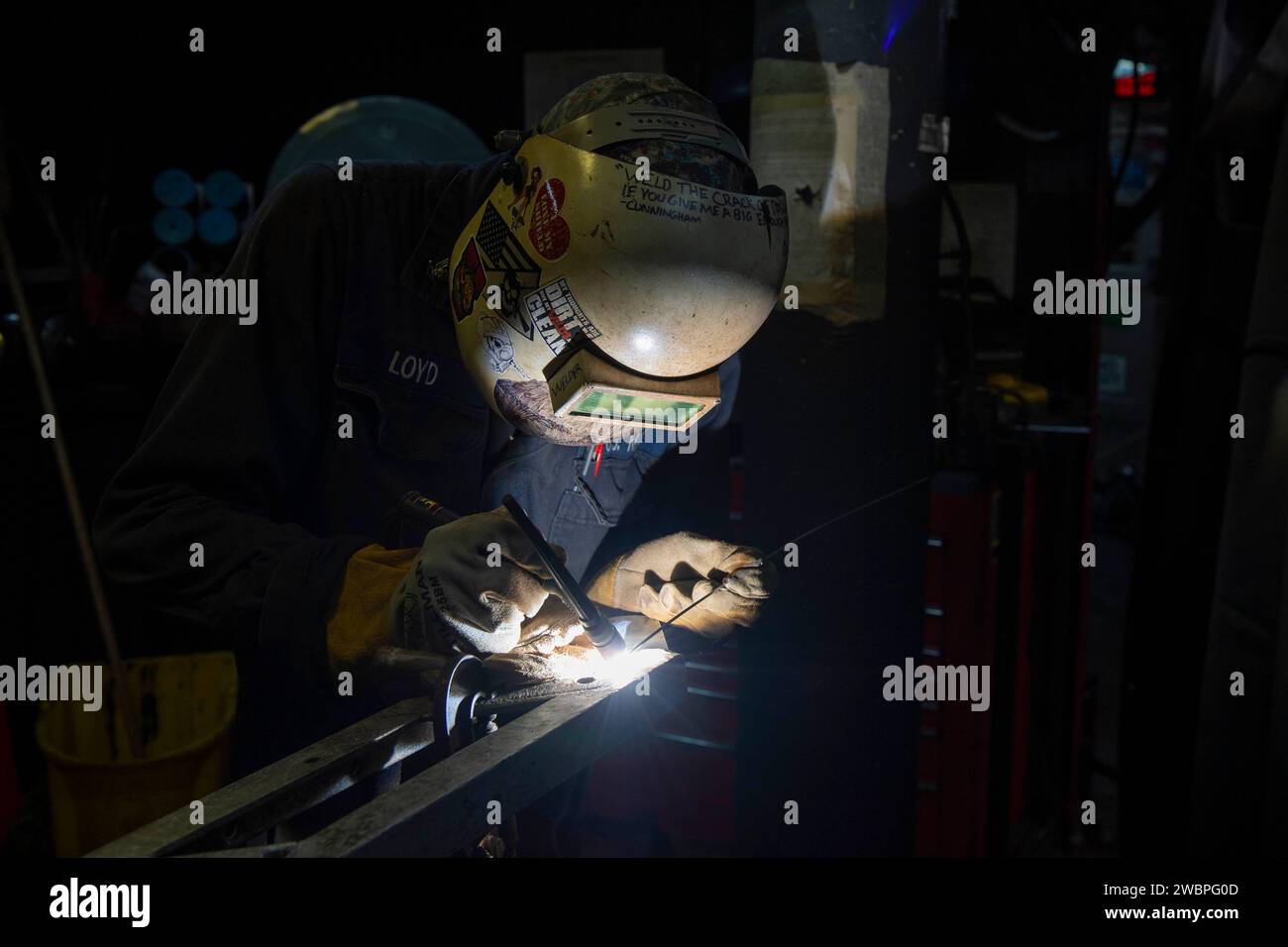 U.S. Navy Hull Maintenance Technician 3rd Class Traven Loyd welds a ...