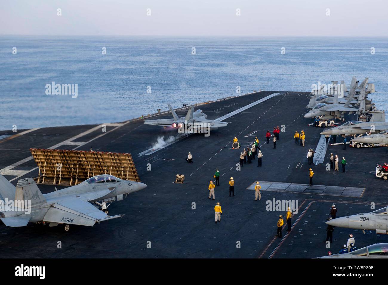 U.S. Navy Sailors participate in flight operations as an F/A-18E Super ...