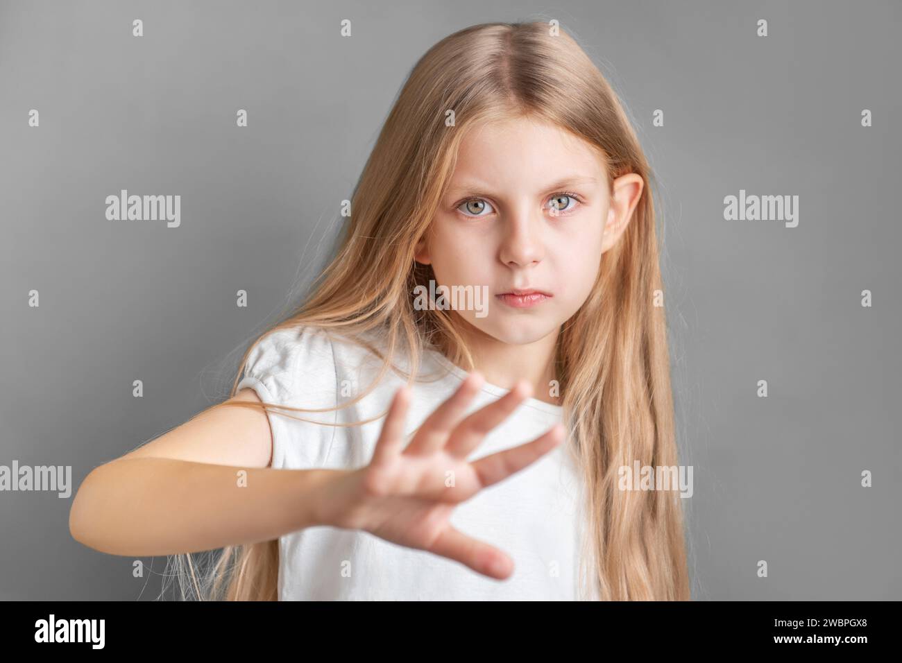 A little child girl showing a sign of protest or refusal with her hand ...