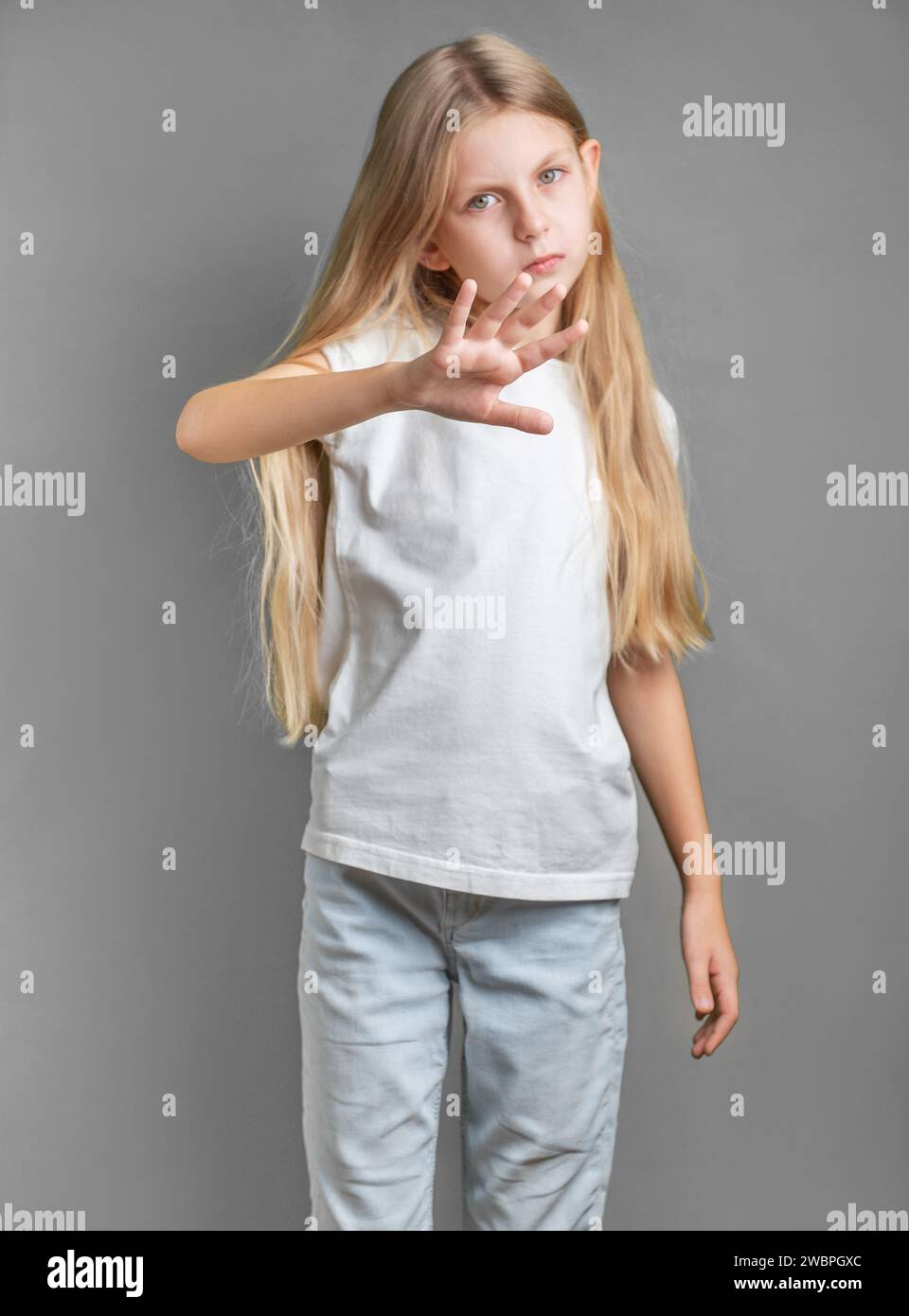 A little child girl showing a sign of protest or refusal with her hand ...