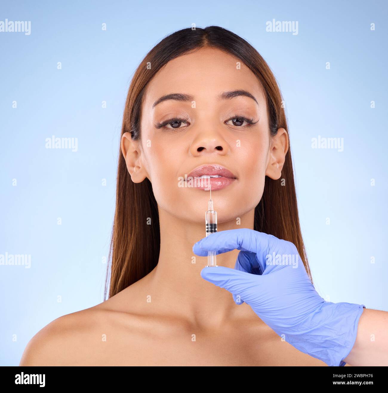 Portrait, lips and injection of woman on studio, blue background and ...