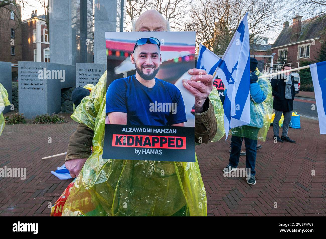 A supporter holds a photo of kidnapped victim held by Hama, during the ...