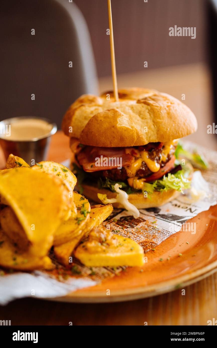 Delicious burger with fried potato Stock Photo - Alamy