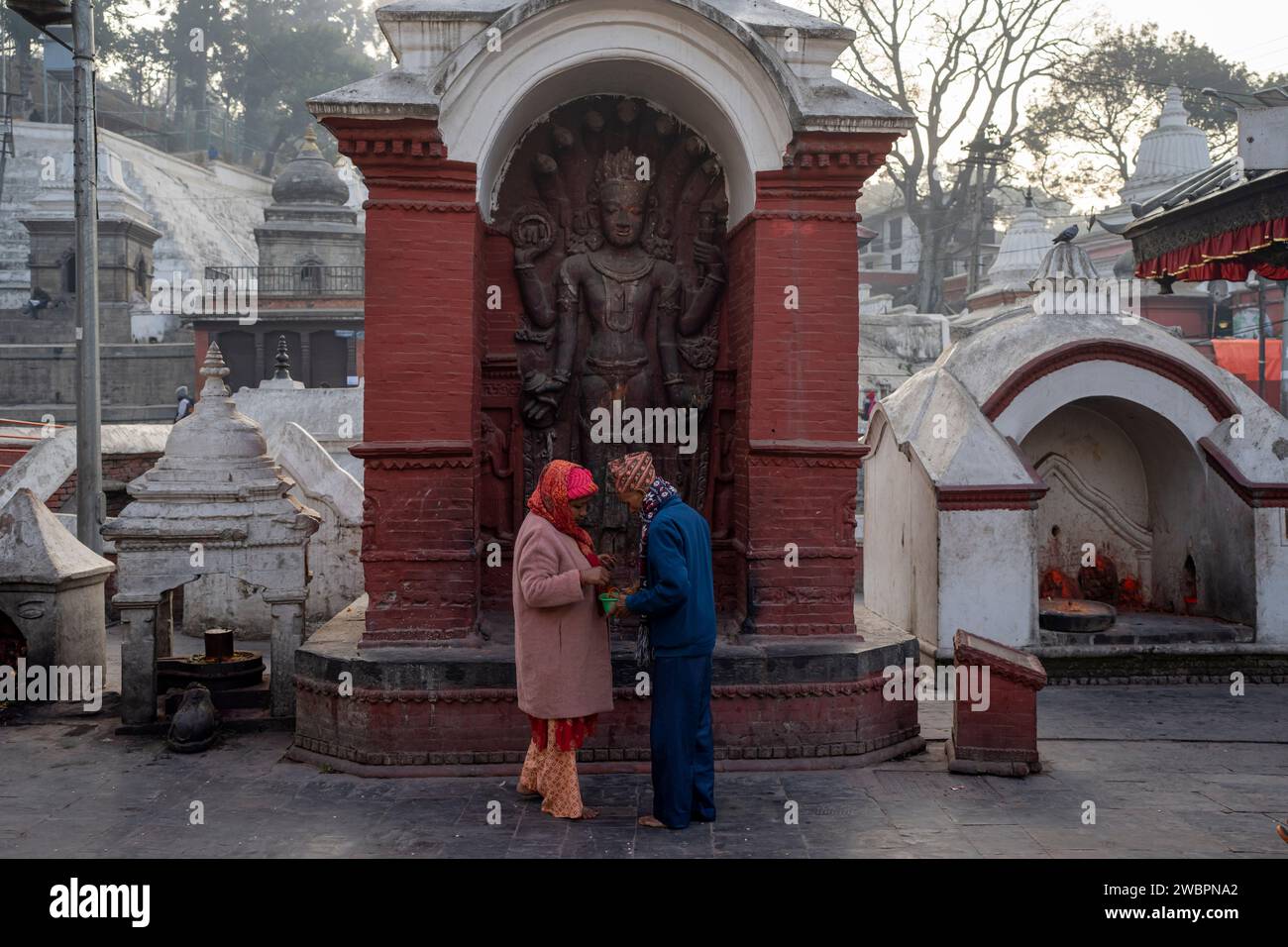 Devotees prepare to perform holy rituals in front of a statue of Hindu ...