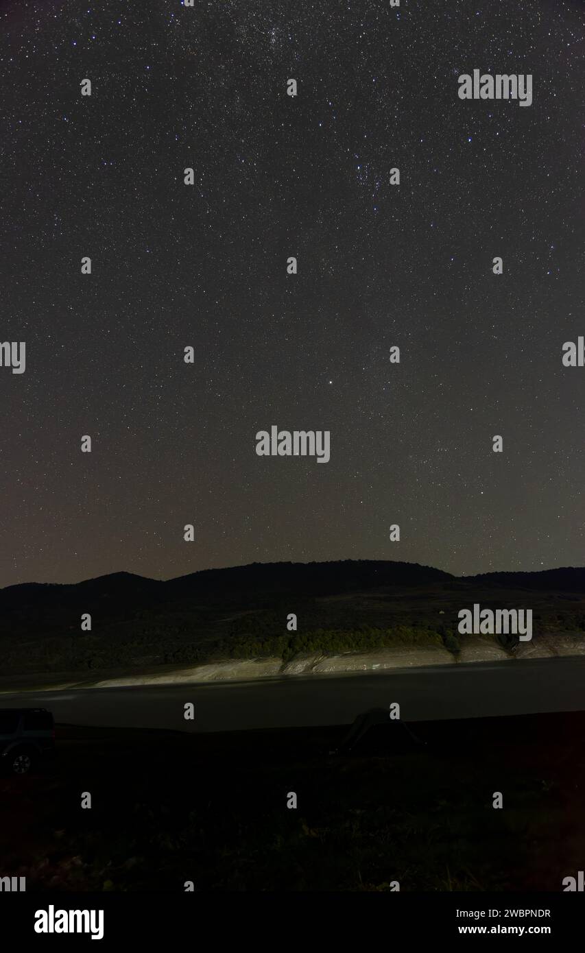 A night sky filled with a myriad of twinkling stars and scattered ...