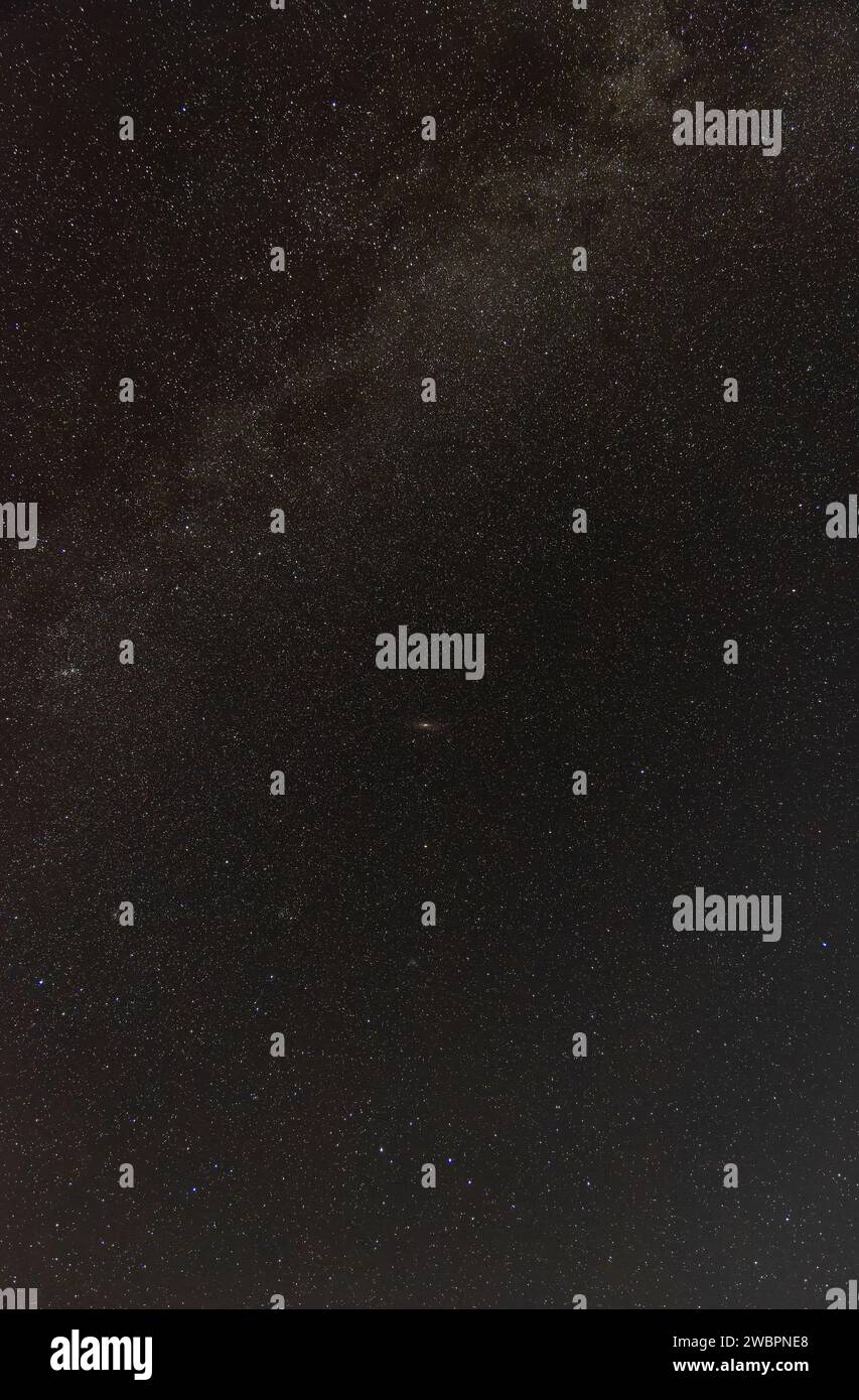 A night sky filled with a myriad of twinkling stars and scattered ...