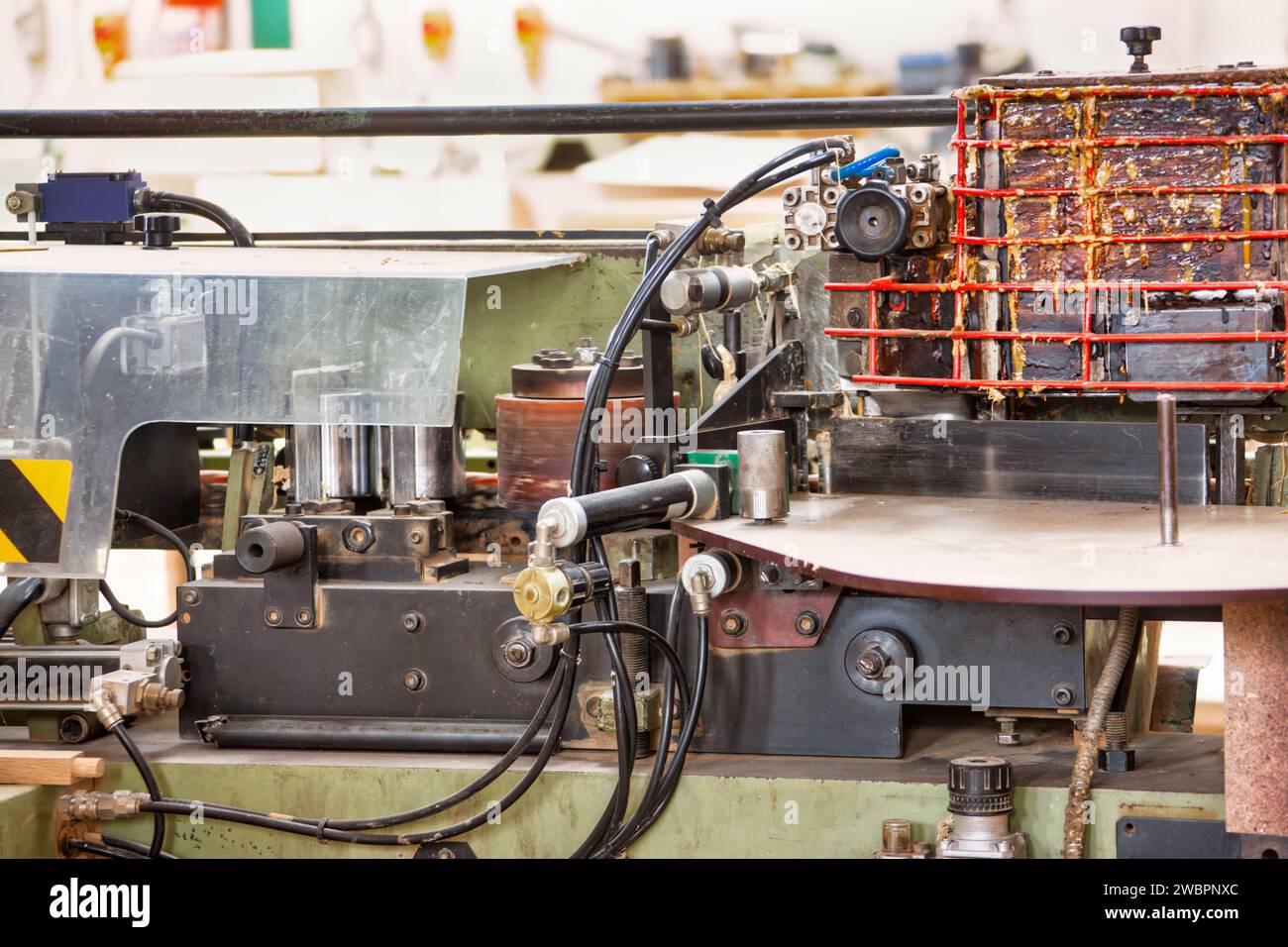 glue machine working in the factory plant for furniture, carpenter ...