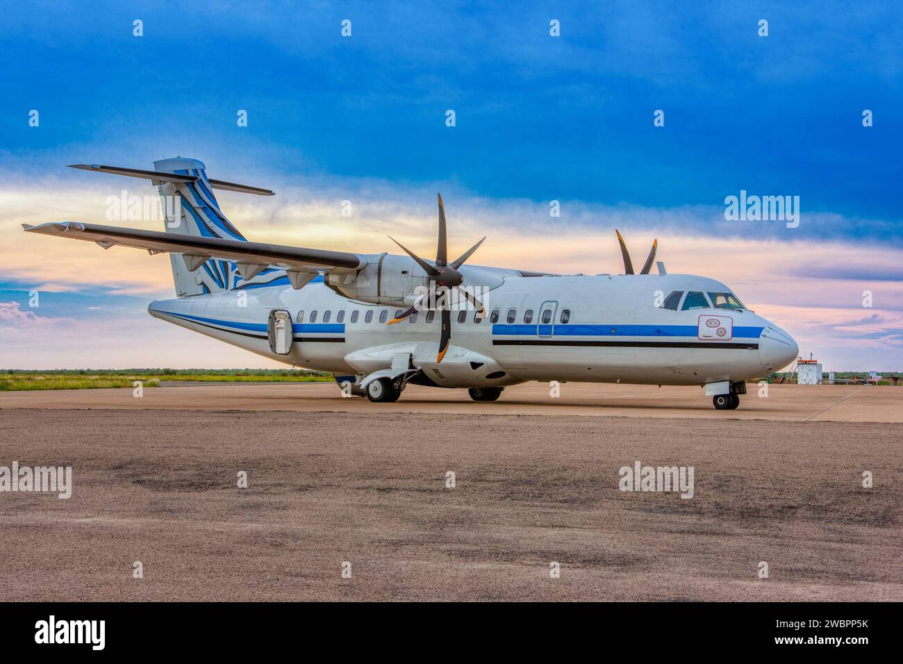propeller plane passenger transport parked in the runway for refueling ...