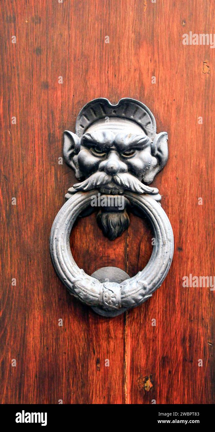 A close-up shot of a sleek metal door handle embedded into a ...