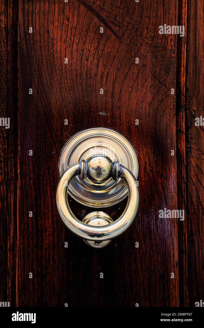 A close-up shot of a sleek metal door handle embedded into a ...