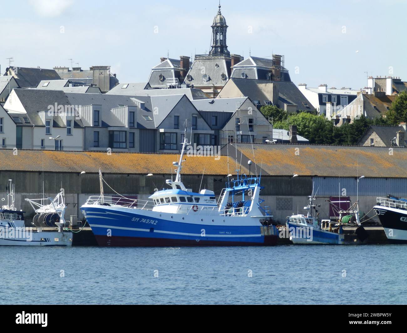 A picturesque marina scene featuring multiple boats in St Malo, France ...