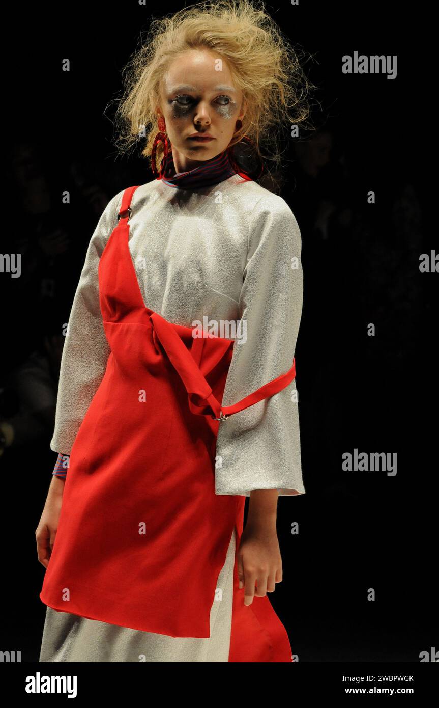 Fashion Model on catwalk wearing a Vermilion, deep vee strap dress worn ...