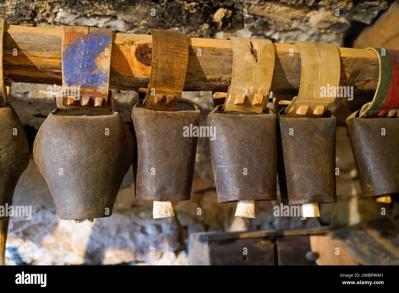Hanging cow sheep bell with a leather strap hanging in a barn vintage ...