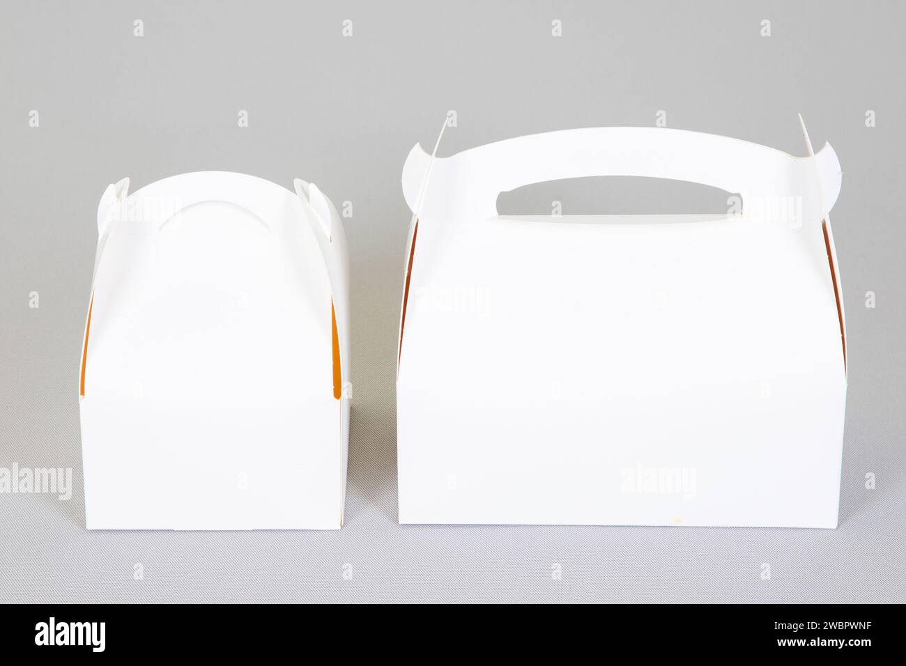 two white boxes mockup blank paper packaging for bakery box empty sign ...