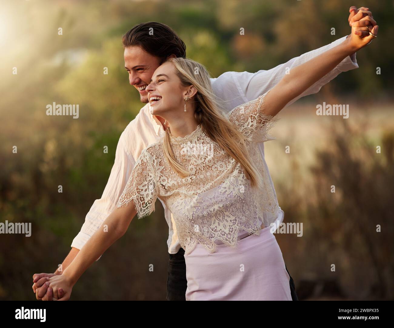 Nature, romance and couple with playful freedom on romantic honeymoon ...