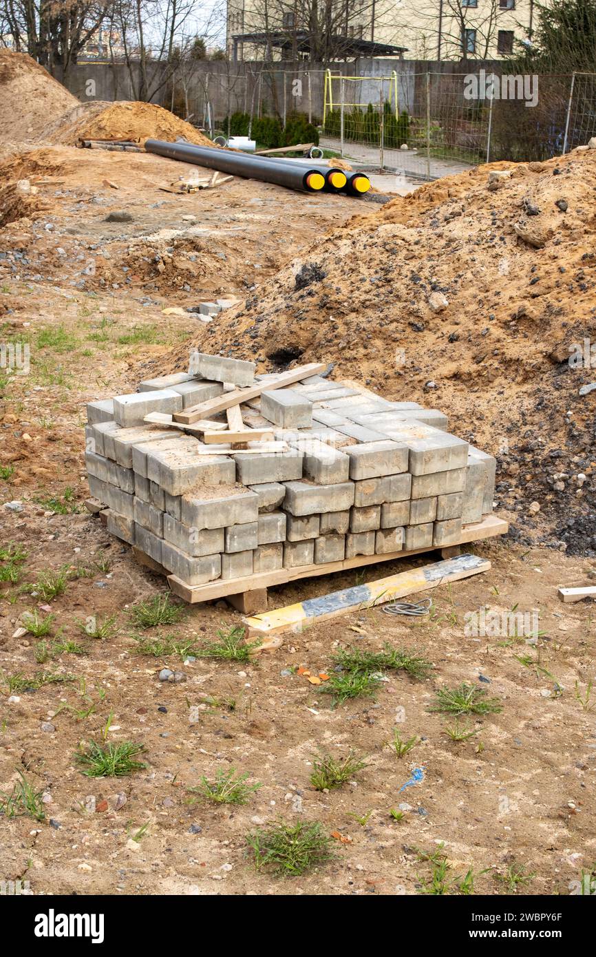 Paving slabs stacked on yellow sand close up Stock Photo - Alamy