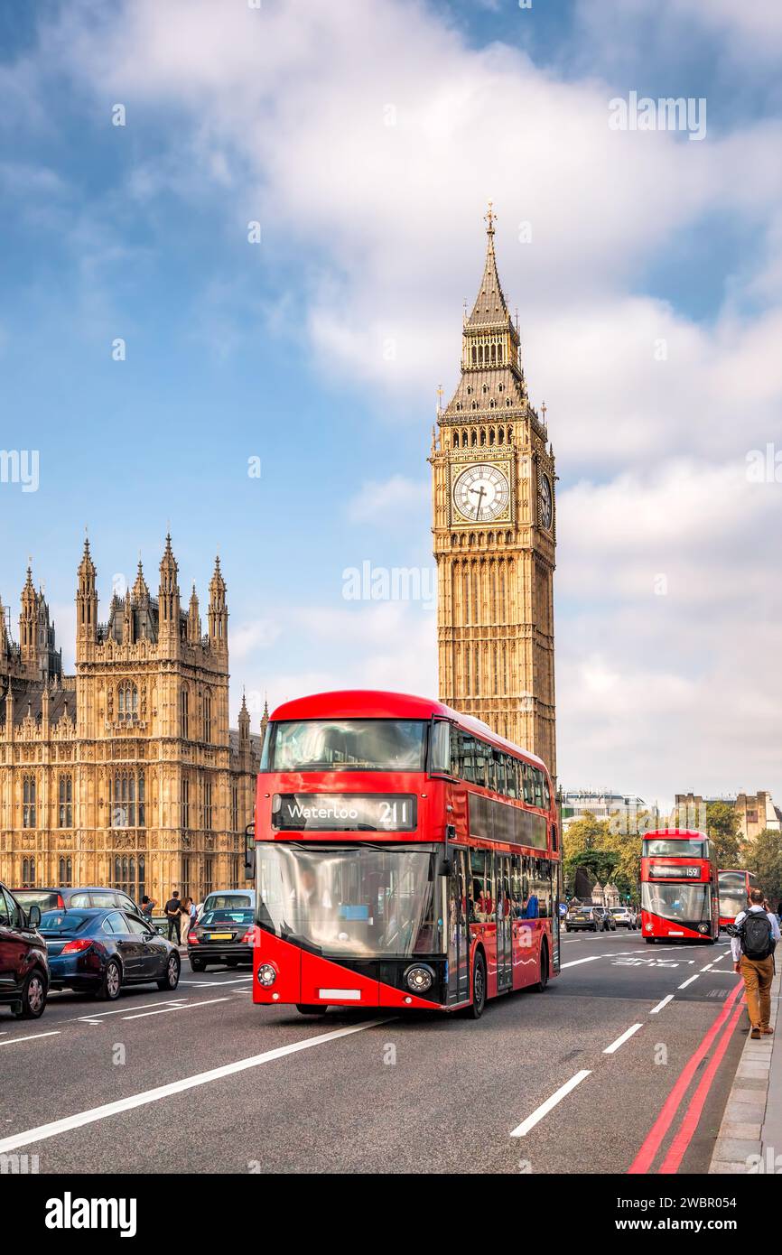 Big Ben with typical red buses on the bridge in London, England, UK ...