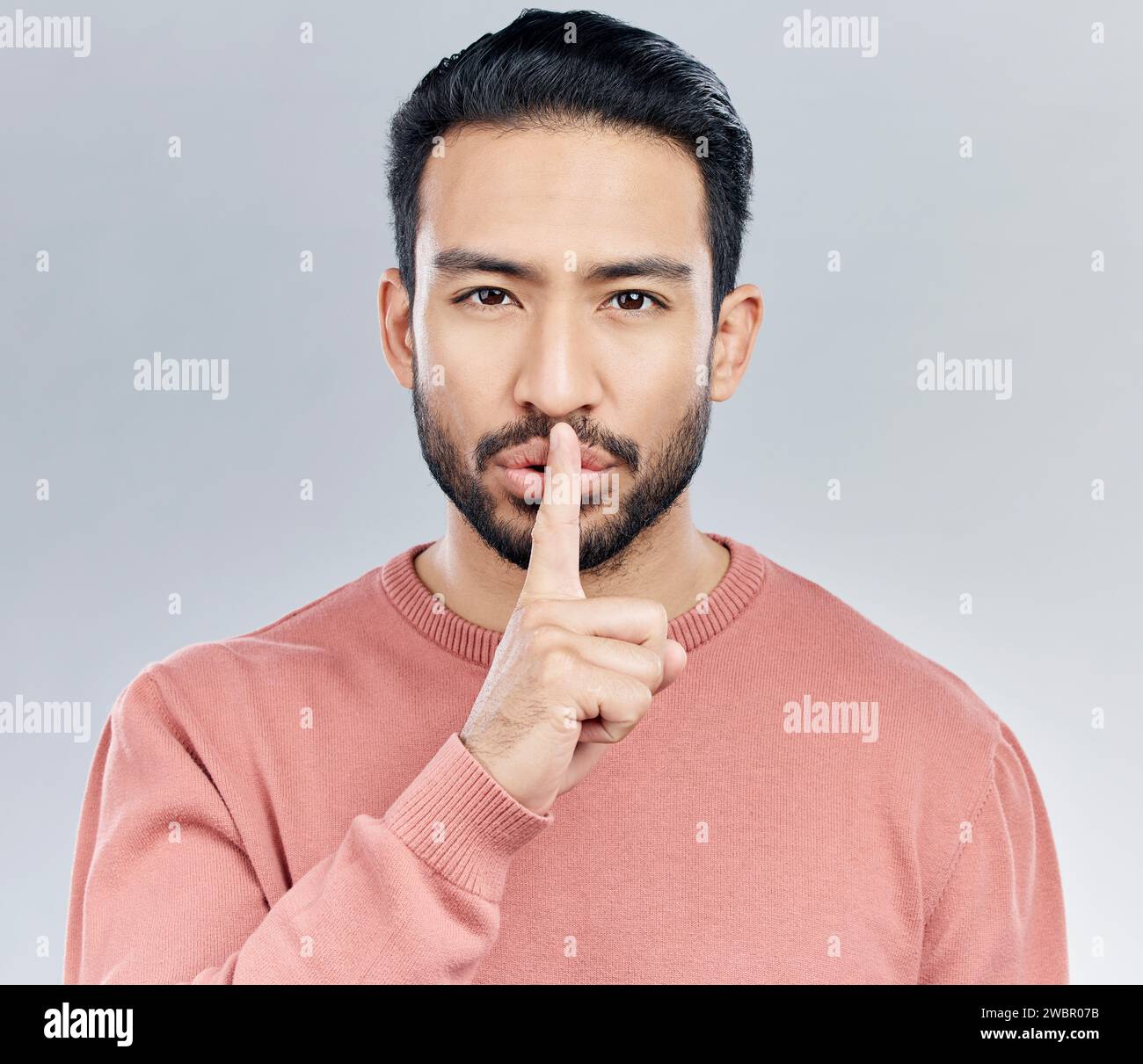 Secret, finger on lips and portrait of man in studio with privacy ...