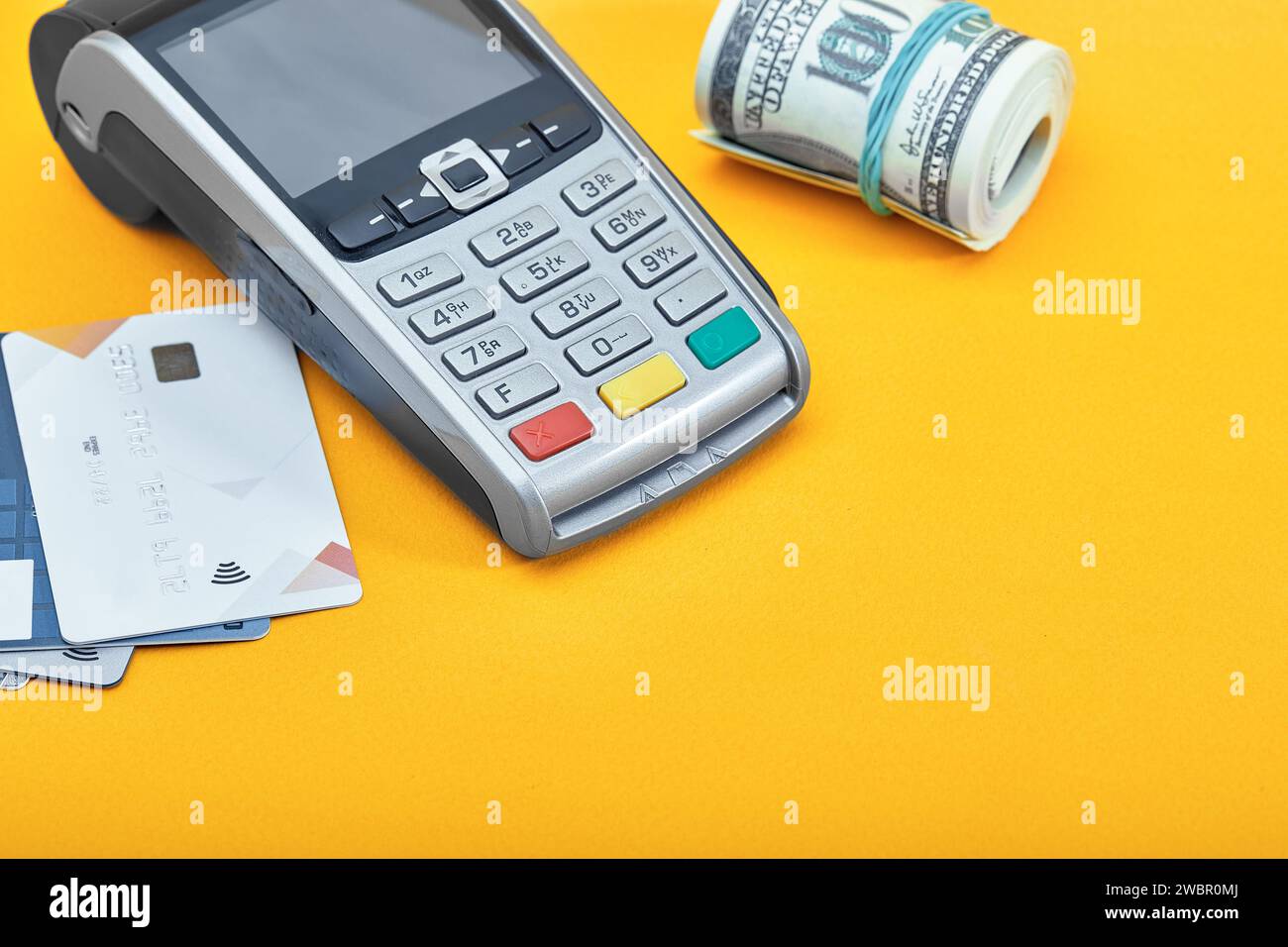 Choice among hundred dollar bills and Credit cards on yellow background ...