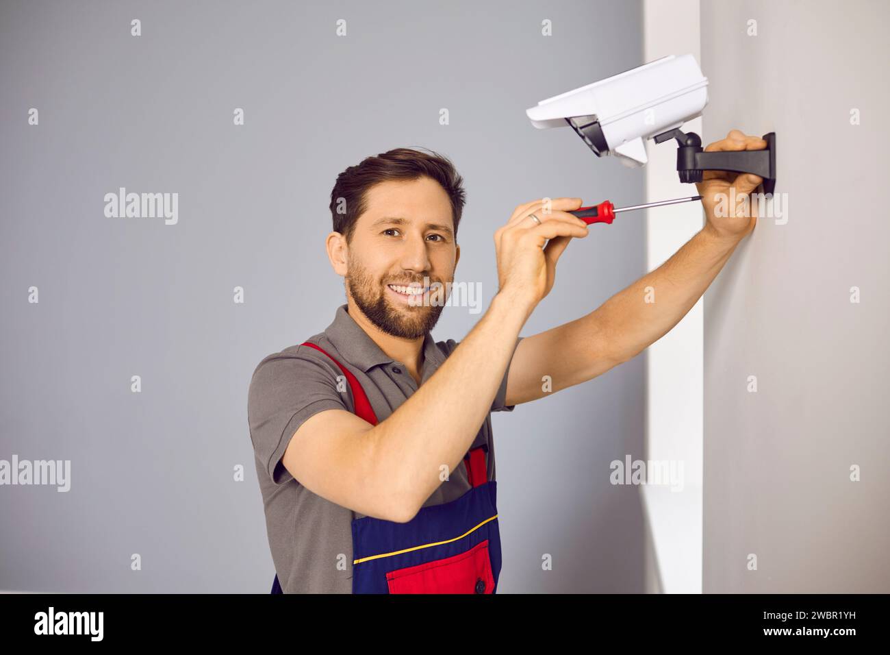 Security surveillance technician adjusting cctv hi-res stock ...