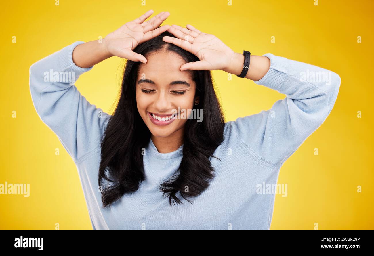 Happy, dance and face of woman on yellow background for positive ...