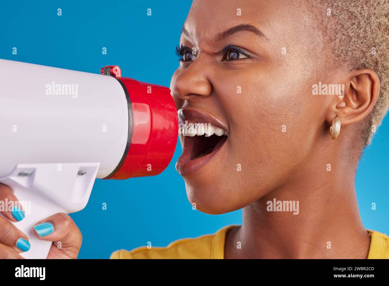 Megaphone, shouting and face of black woman in studio for message ...