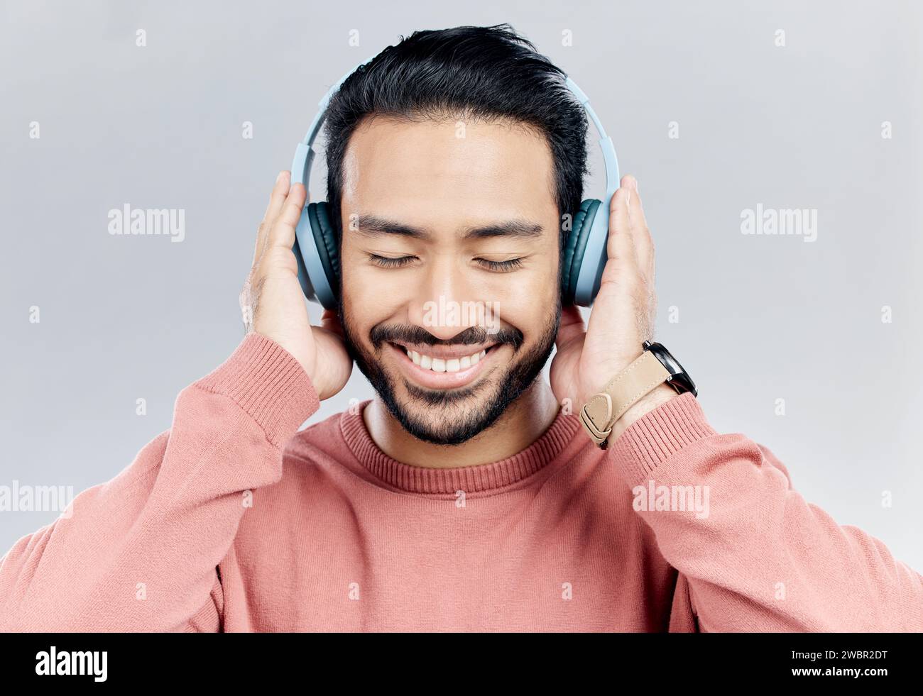 Happy, music and Asian man with headphones, streaming and cheerful on a ...
