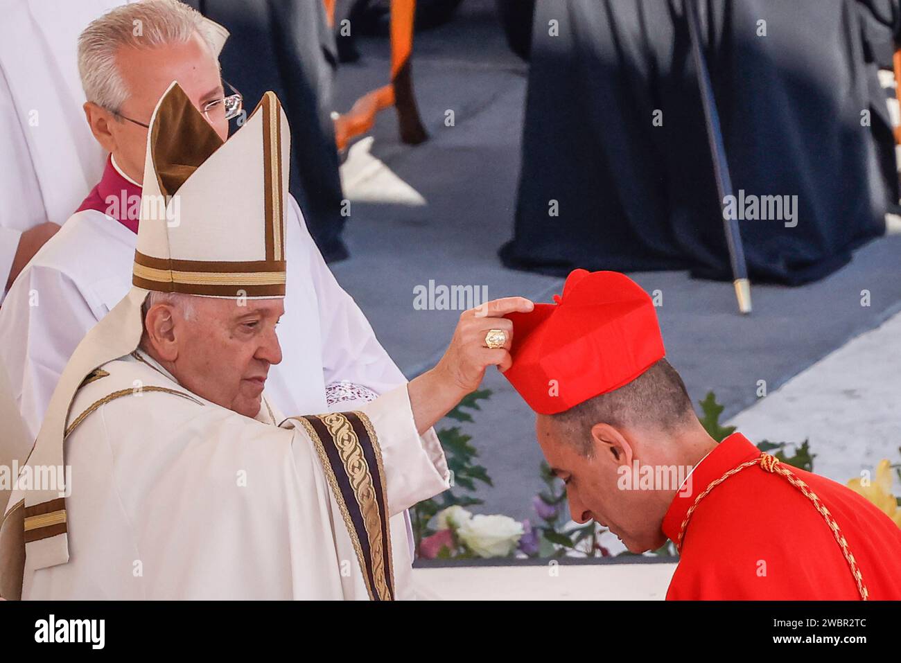 Pope Francis puts the red biretta on the head of new cardinal Victor ...