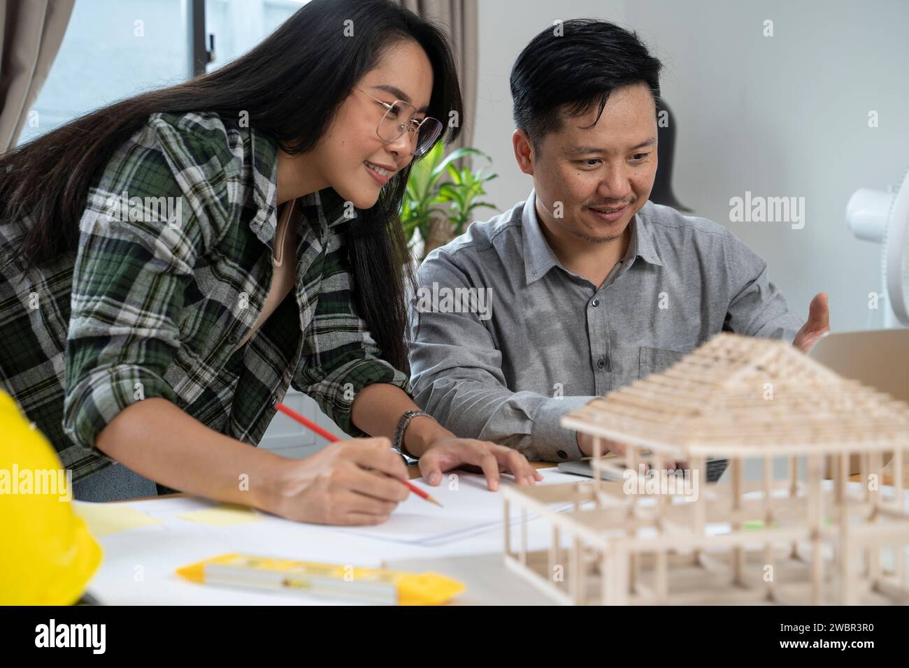 Architect women discussion around blueprint in office Stock Photo - Alamy