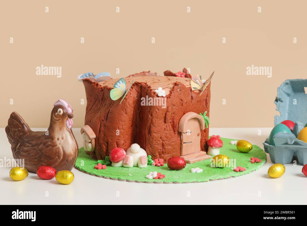 Easter log cake with textured look on the tree trunk and Easter bunny ...