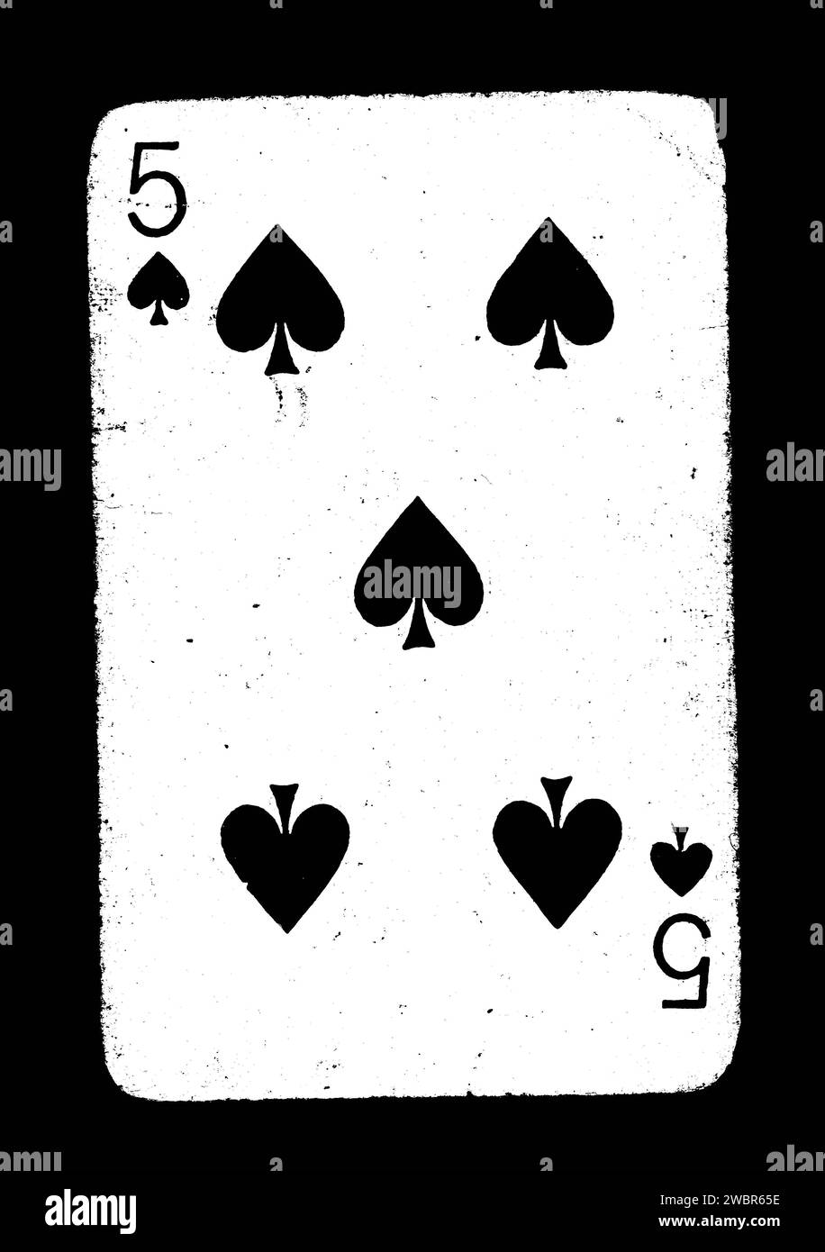 A vintage five of spades playing card isolated on a black background ...