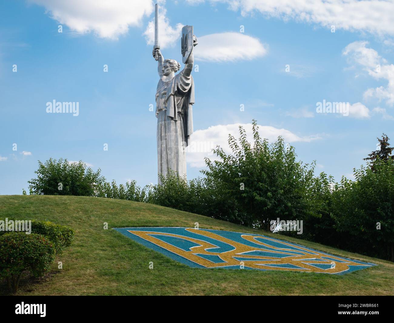 Ukrainian Motherland Monument against a sky with clouds and the state ...