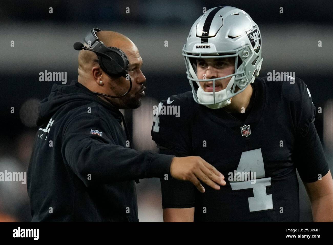 Las Vegas Raiders interim head coach Antonio Pierce speaks with Las Vegas Raiders quarterback ...