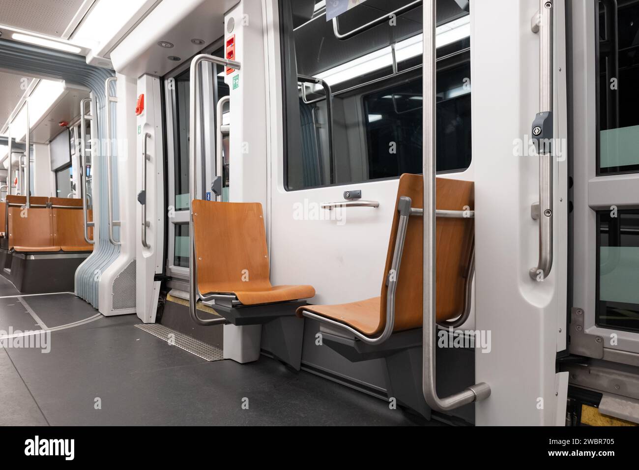 Empty public transportation tram car. Inside shot, nighttime, no people ...