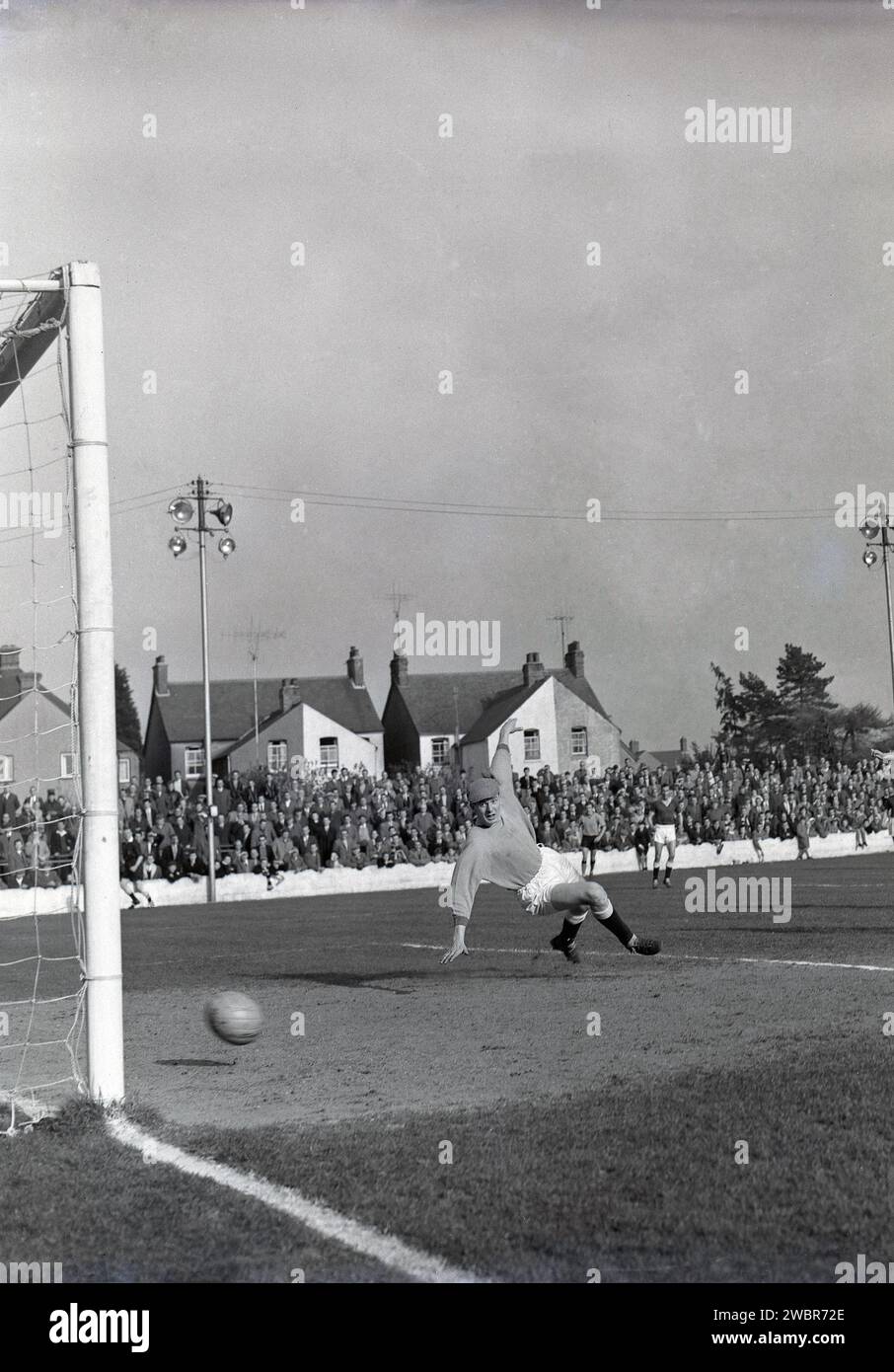 1960, historical, football match, goalkeeper beaten as the ball enters ...